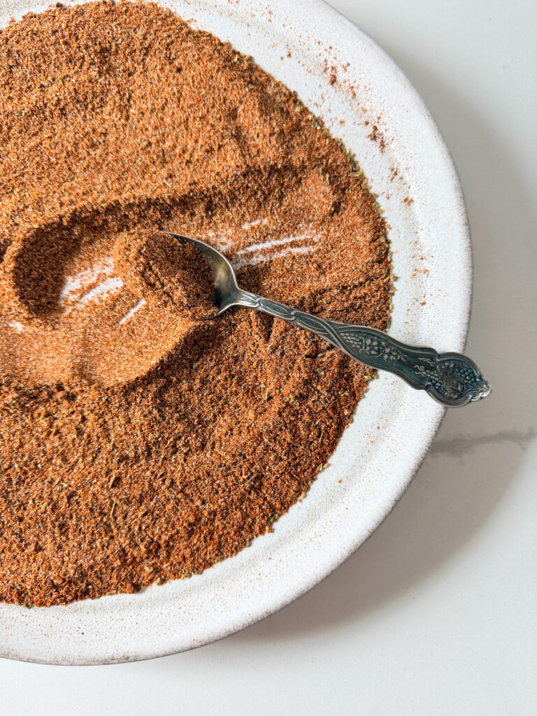 Taco Seasoning on plate with spoon - The Perks of Being Us